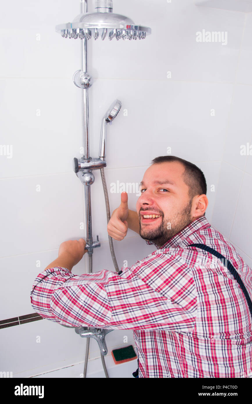 Handyman fixing the shower the bathroom Stock Photo - Alamy