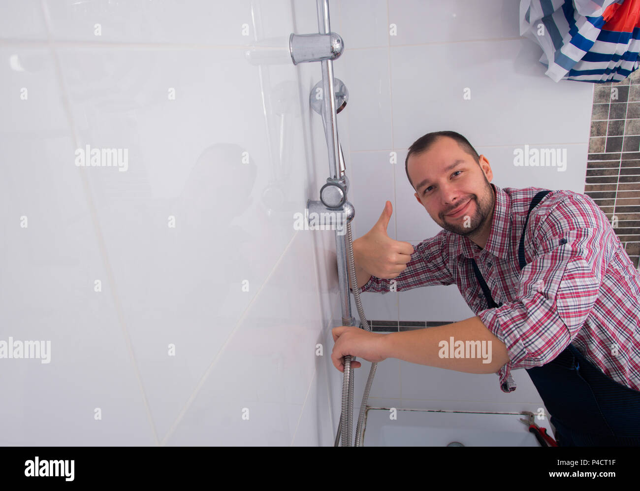 Handyman fixing the shower the bathroom Stock Photo - Alamy