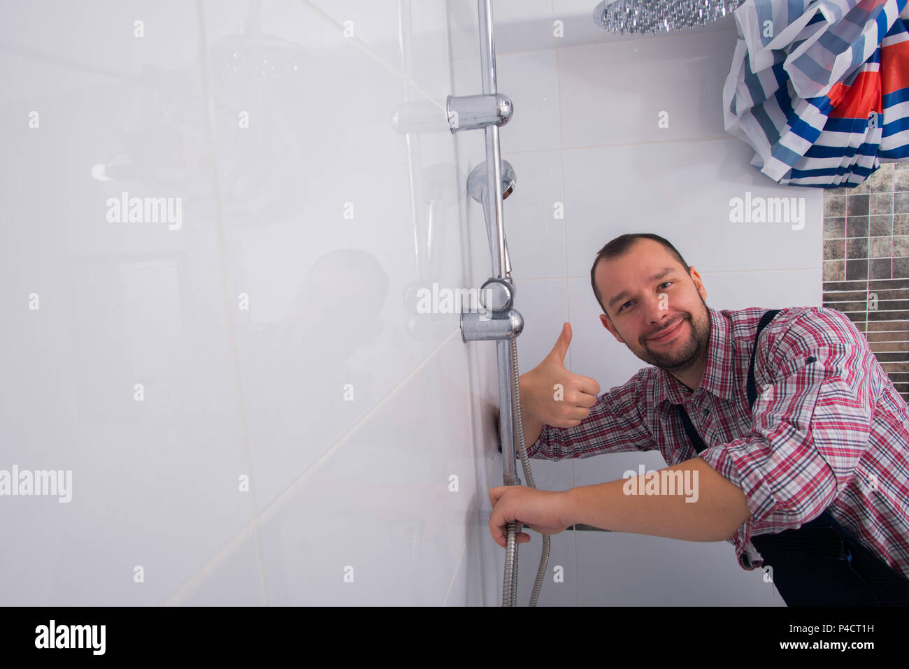 Handyman fixing the shower the bathroom Stock Photo - Alamy