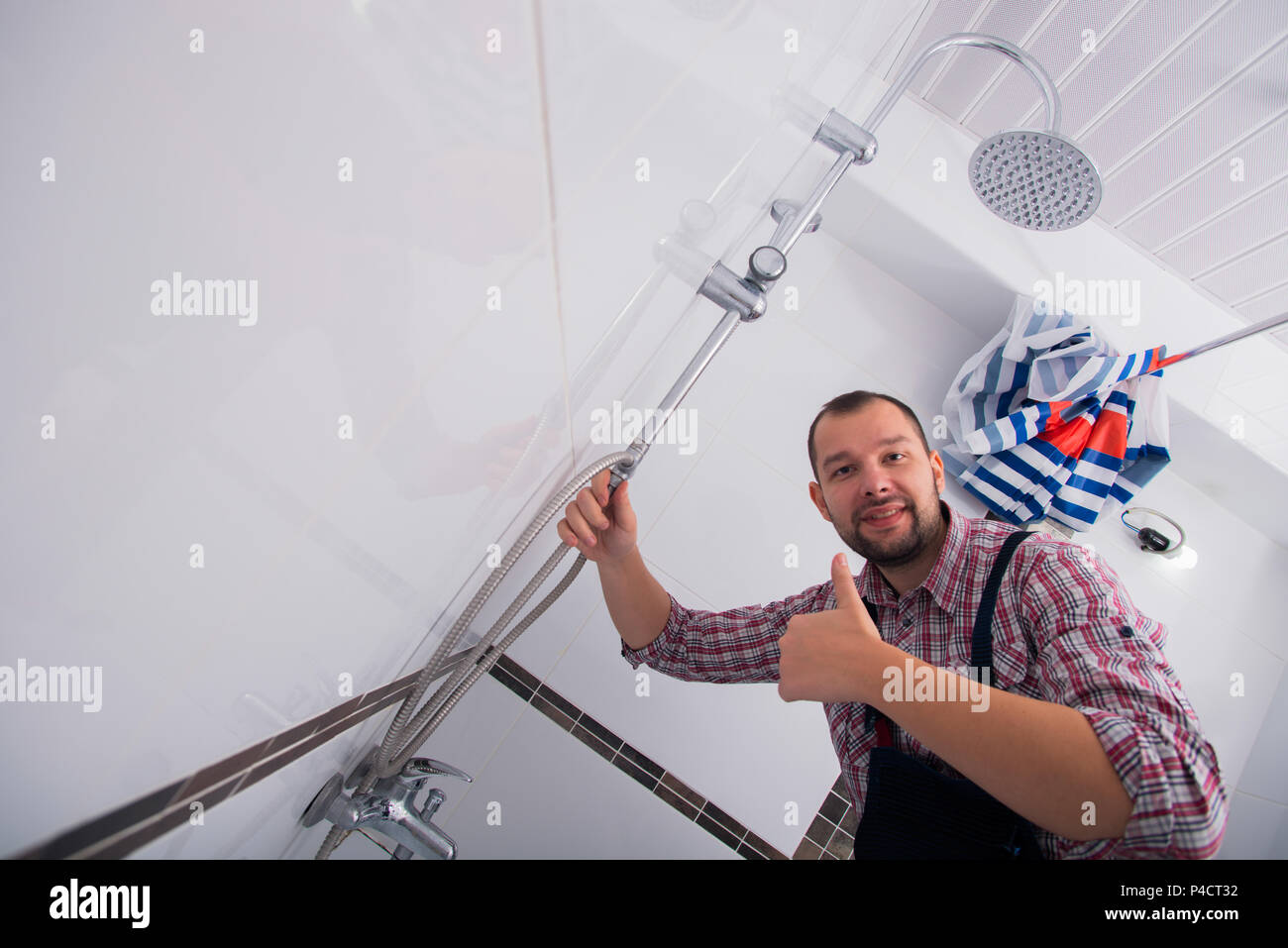 Handyman fixing the shower the bathroom Stock Photo - Alamy