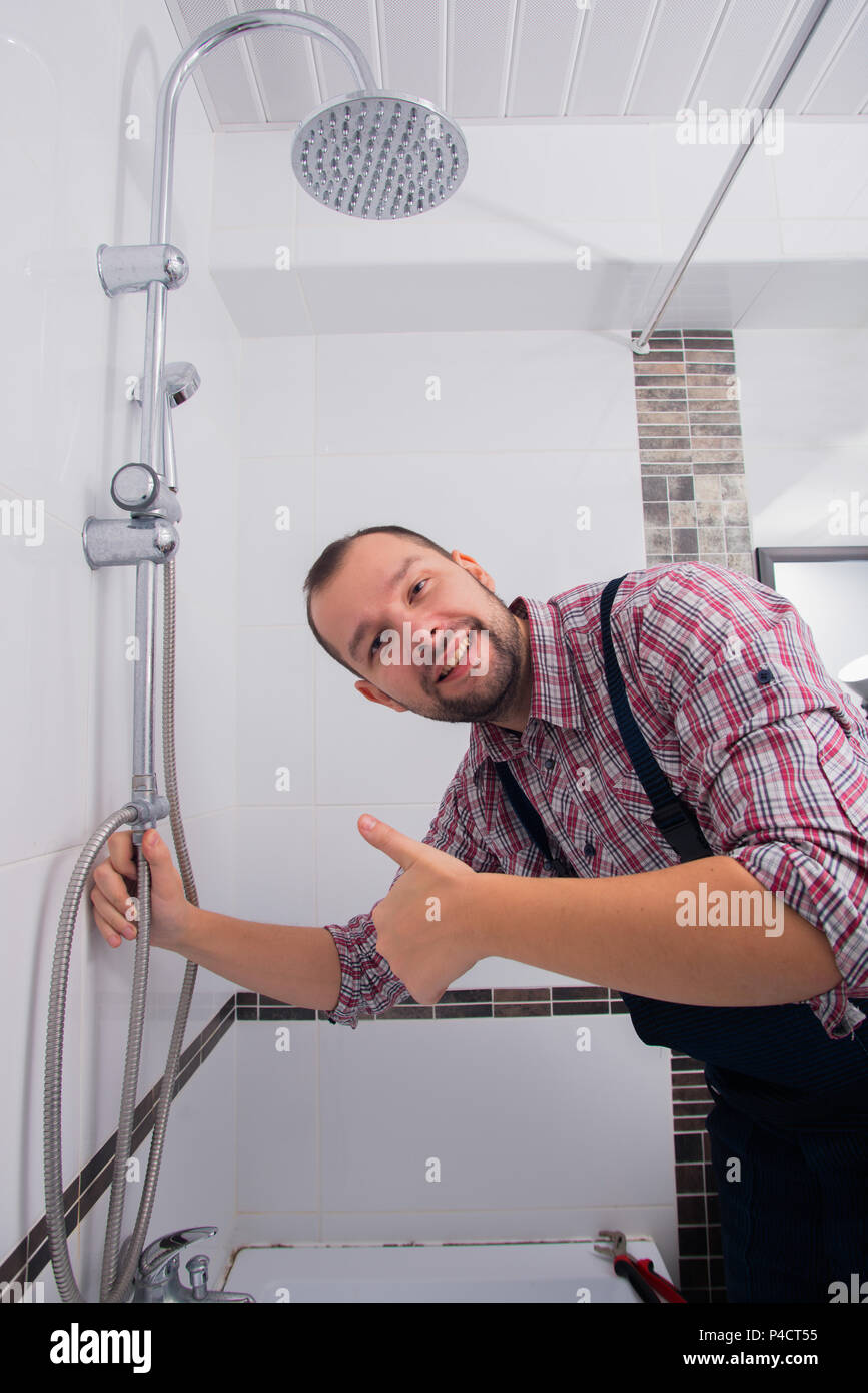 Handyman fixing the shower the bathroom Stock Photo - Alamy