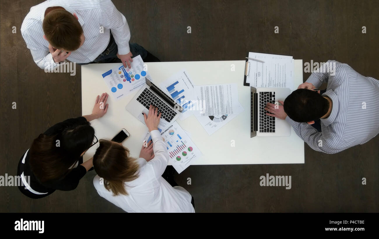 Young office employees discussing papers at business meeting Stock ...