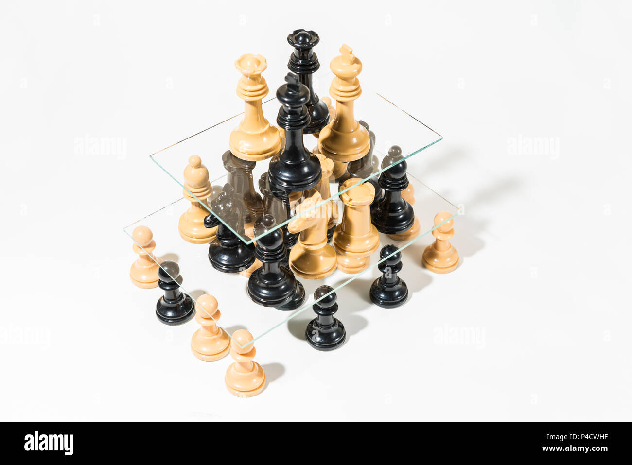 Chess pieces on white background forming a pyramid. Conceptual ...