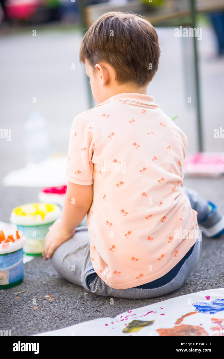 Image of cute boy who painting on canvas into the park taking from ...