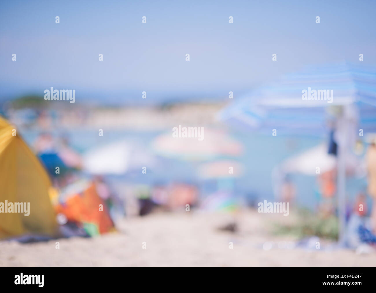 Blurred Background on a sunny day on the beach with clear blue sky and ...