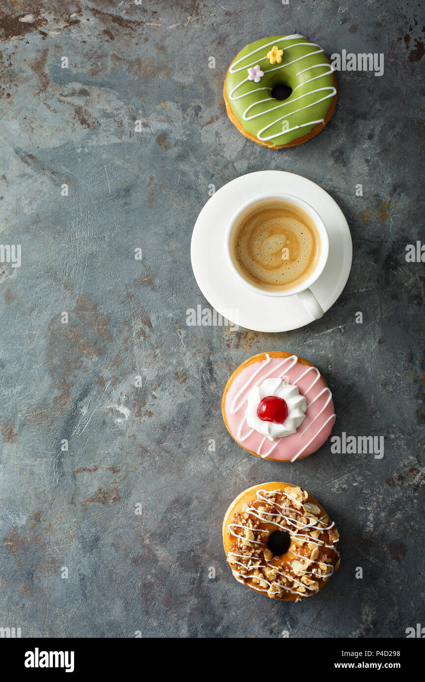 Sweet donuts with coffee overhead view Stock Photo - Alamy