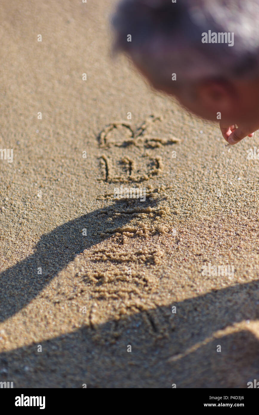 Handwritten message on the sand on a beach near the water Stock Photo ...