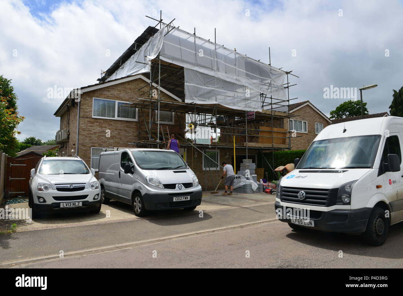 A work scene with labourers building a house extension Stock Photo - Alamy