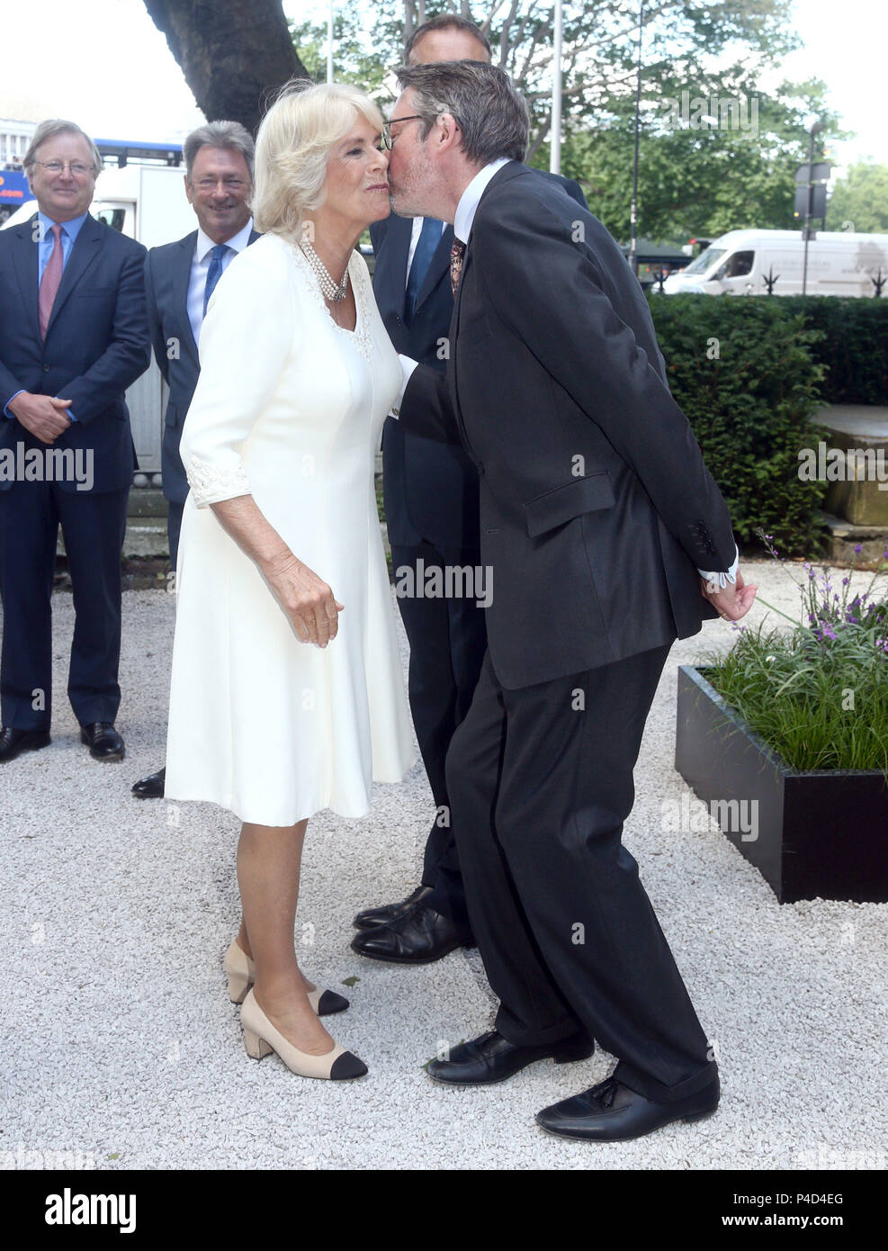 The Duchess of Cornwall is greeted by florist Shane Connolly (right ...