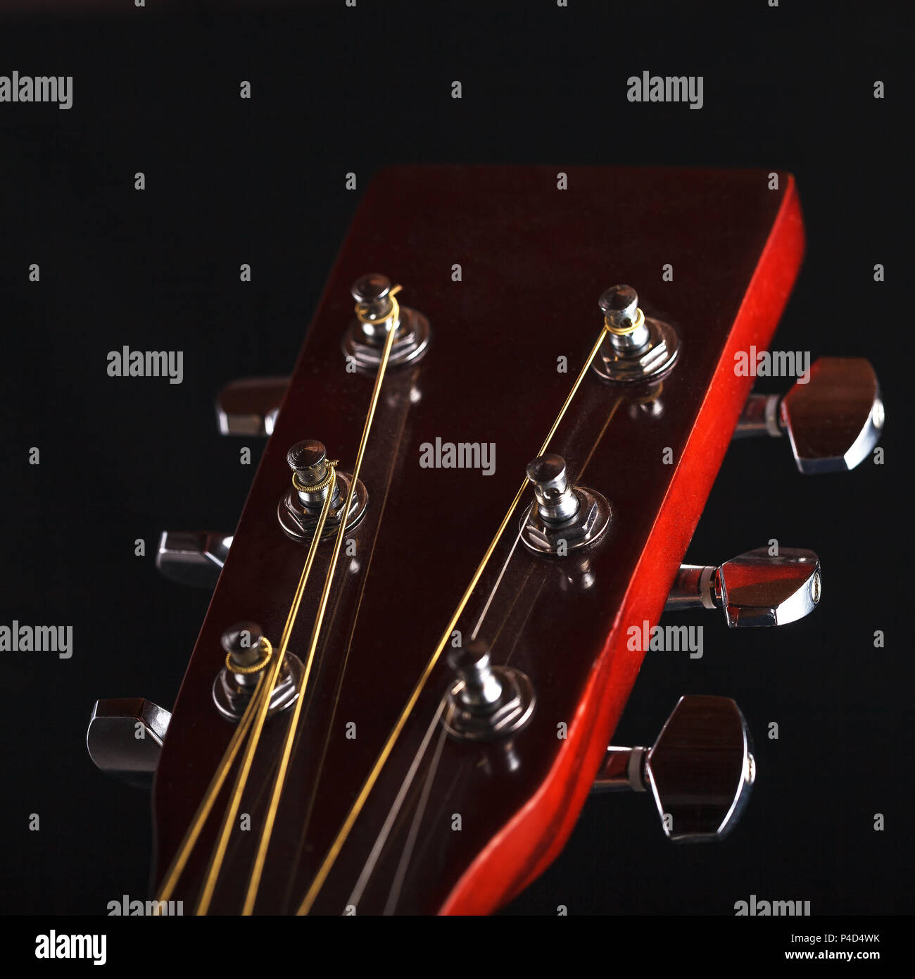 The upper part of the guitar neck with strings stretched against a ...