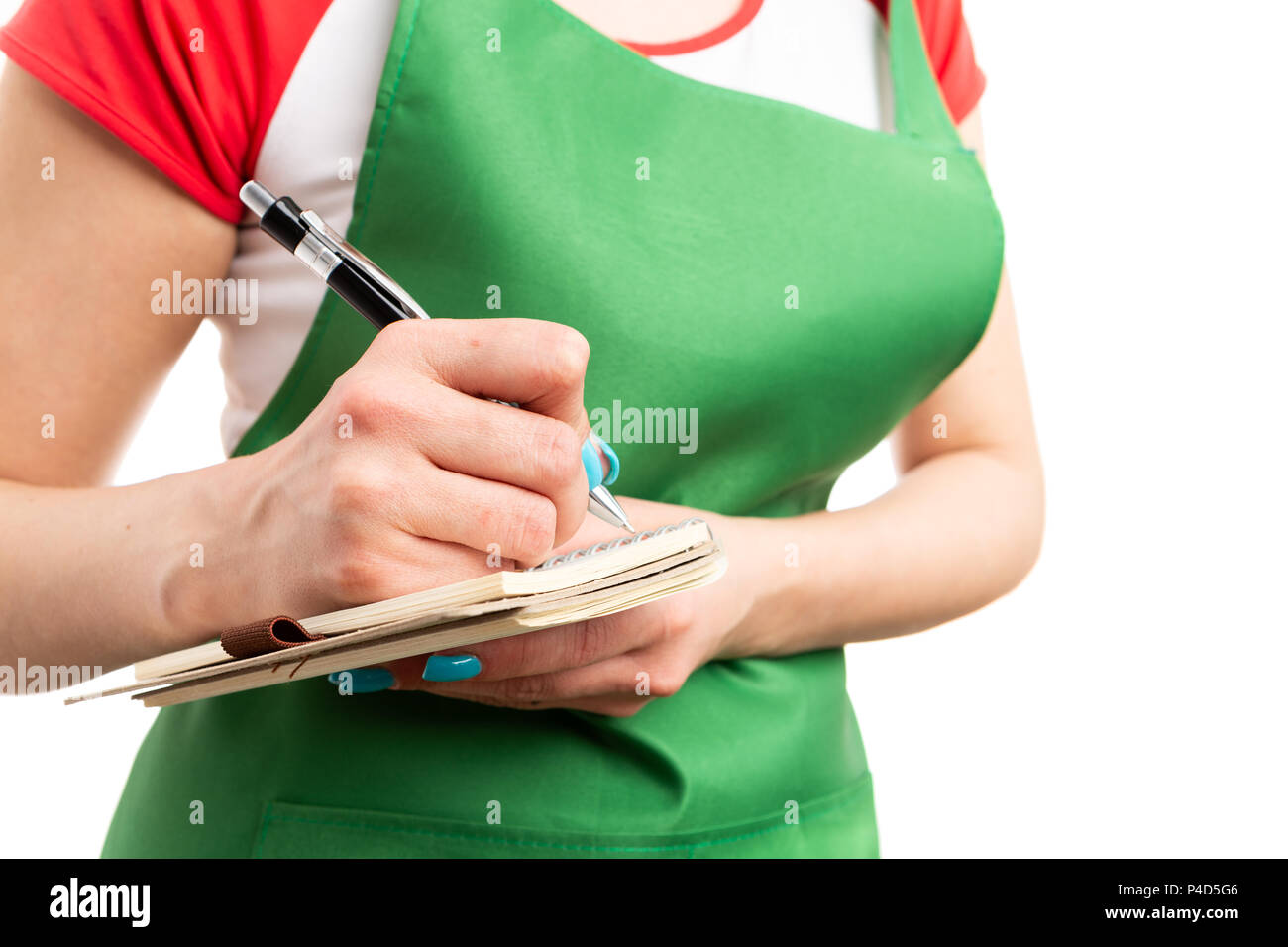 Close-up of female retail or supermarket employee hands taking notes in ...