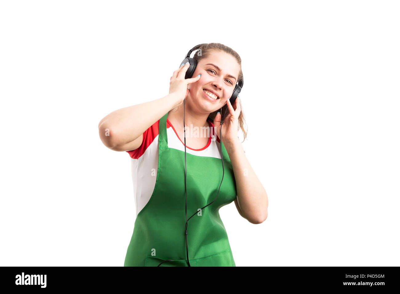 Young cheerful woman supermarket or retail employee listening to music ...