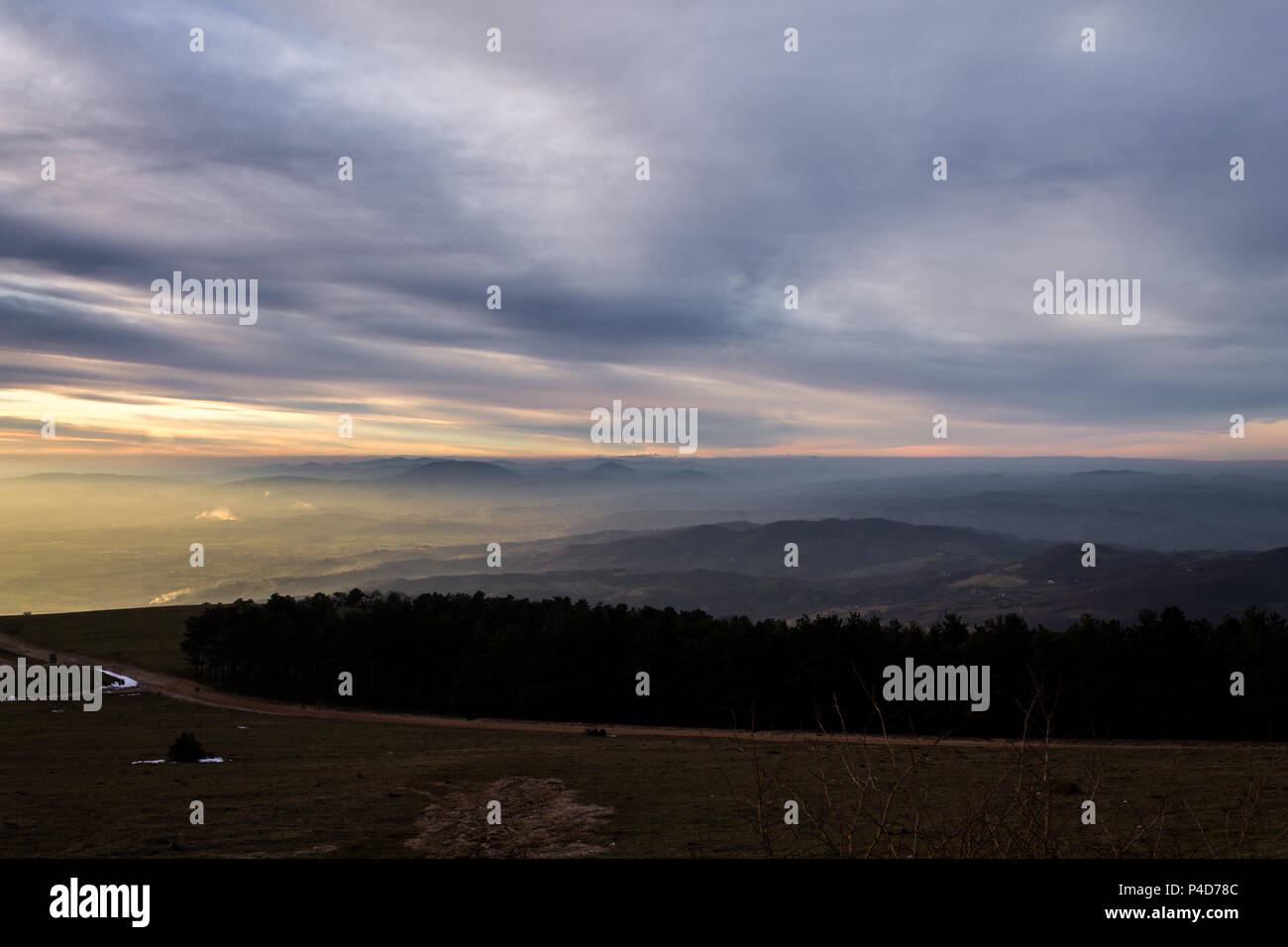 Subasio Mt. (Umbria, Italy), with sky covered by clouds and warm sunset ...
