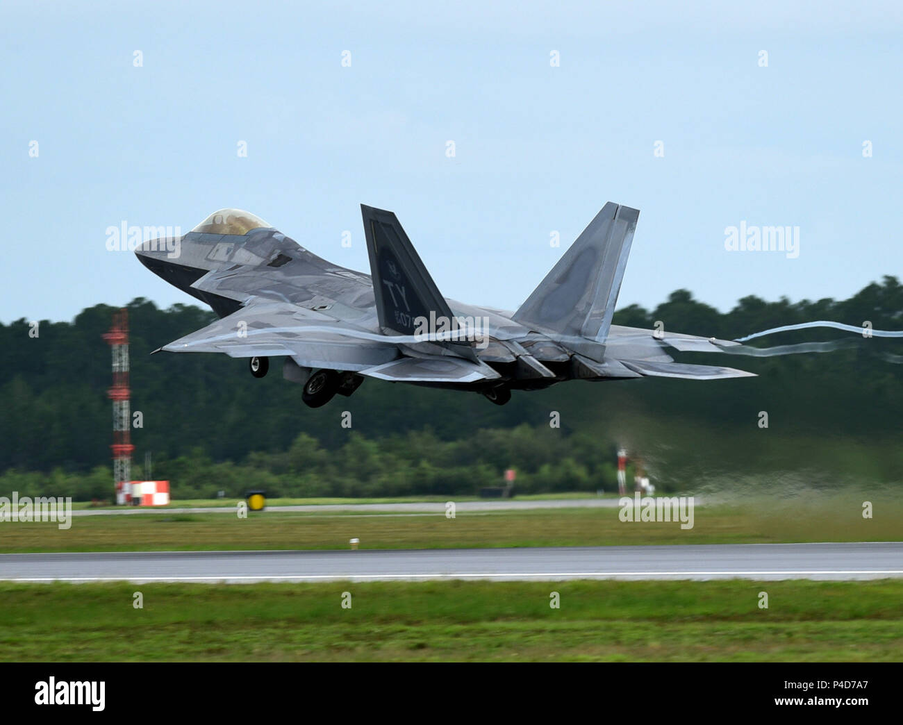 A U.S. Air Force F-22 Raptor from the 95th Fighter Squadron retracts ...