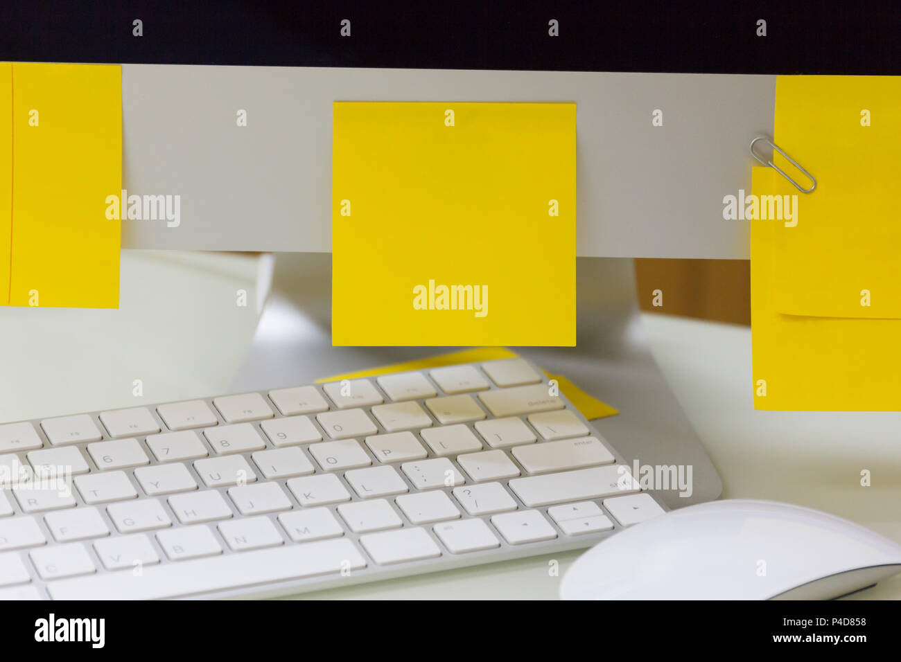 Empty yellow sticky note on computer, work business desk Stock Photo ...