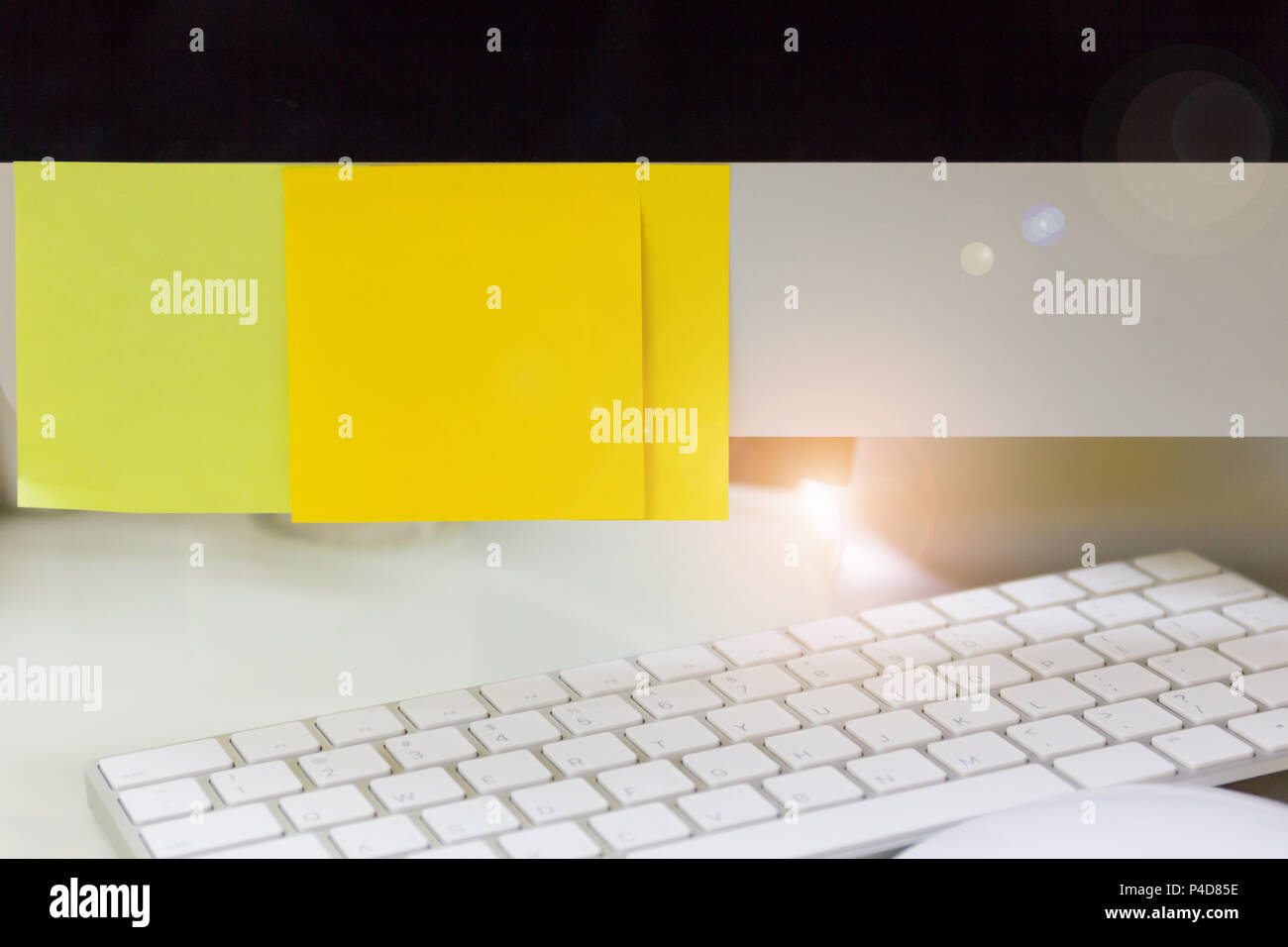 Empty yellow sticky note on computer, work business desk Stock Photo ...