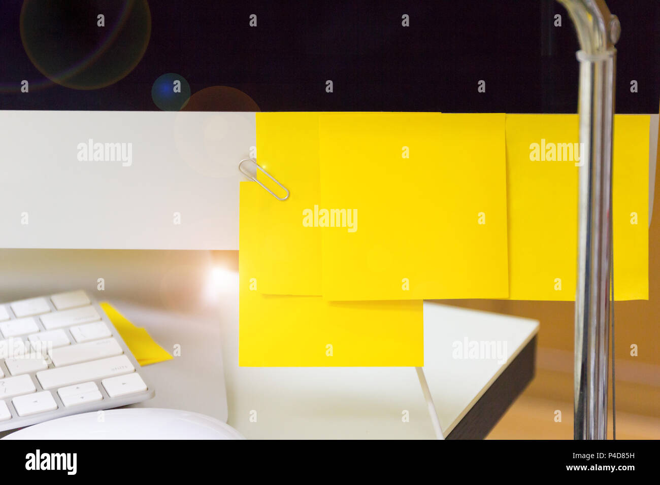 Empty yellow sticky note on computer, work business desk Stock Photo ...