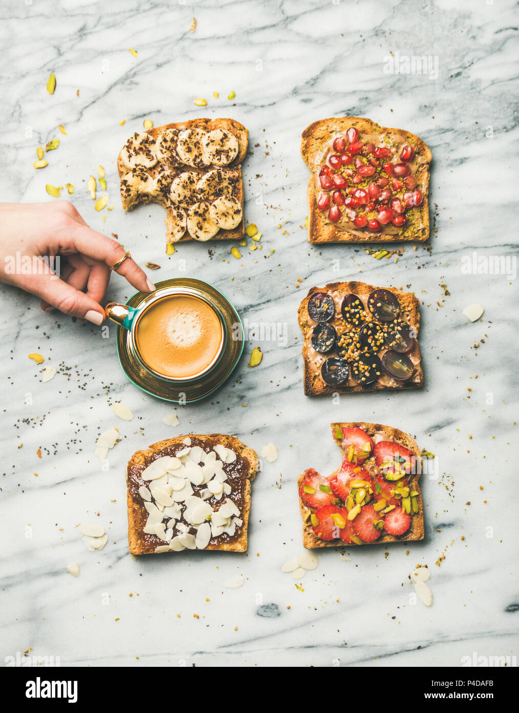 Healthy breakfast with wholegrain toasts and woman's hand taking coffee ...