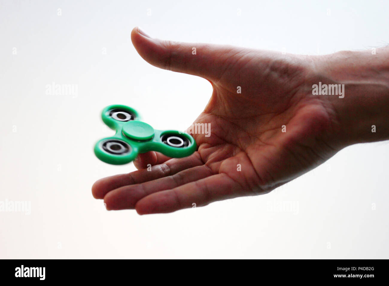 Man holding playing fidget spinner hi-res stock photography and images ...