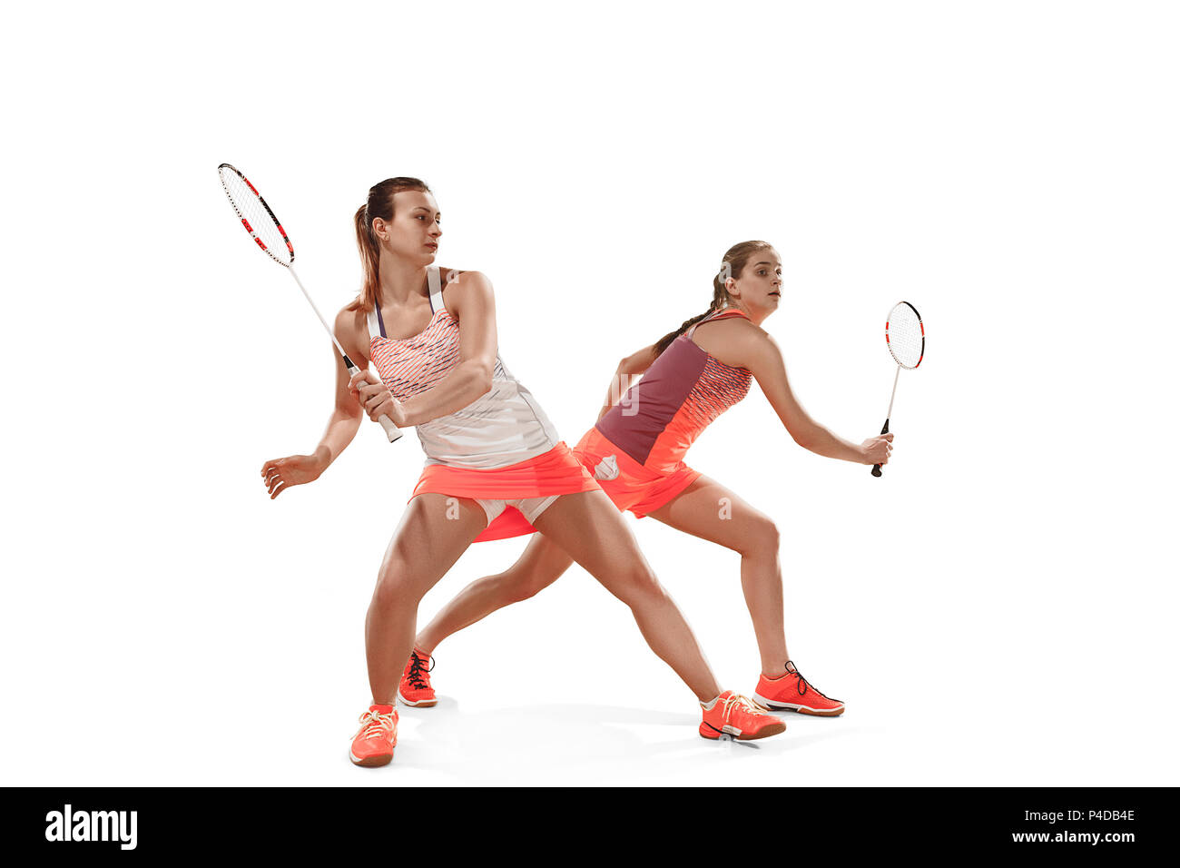 Young women playing badminton over white background Stock Photo - Alamy