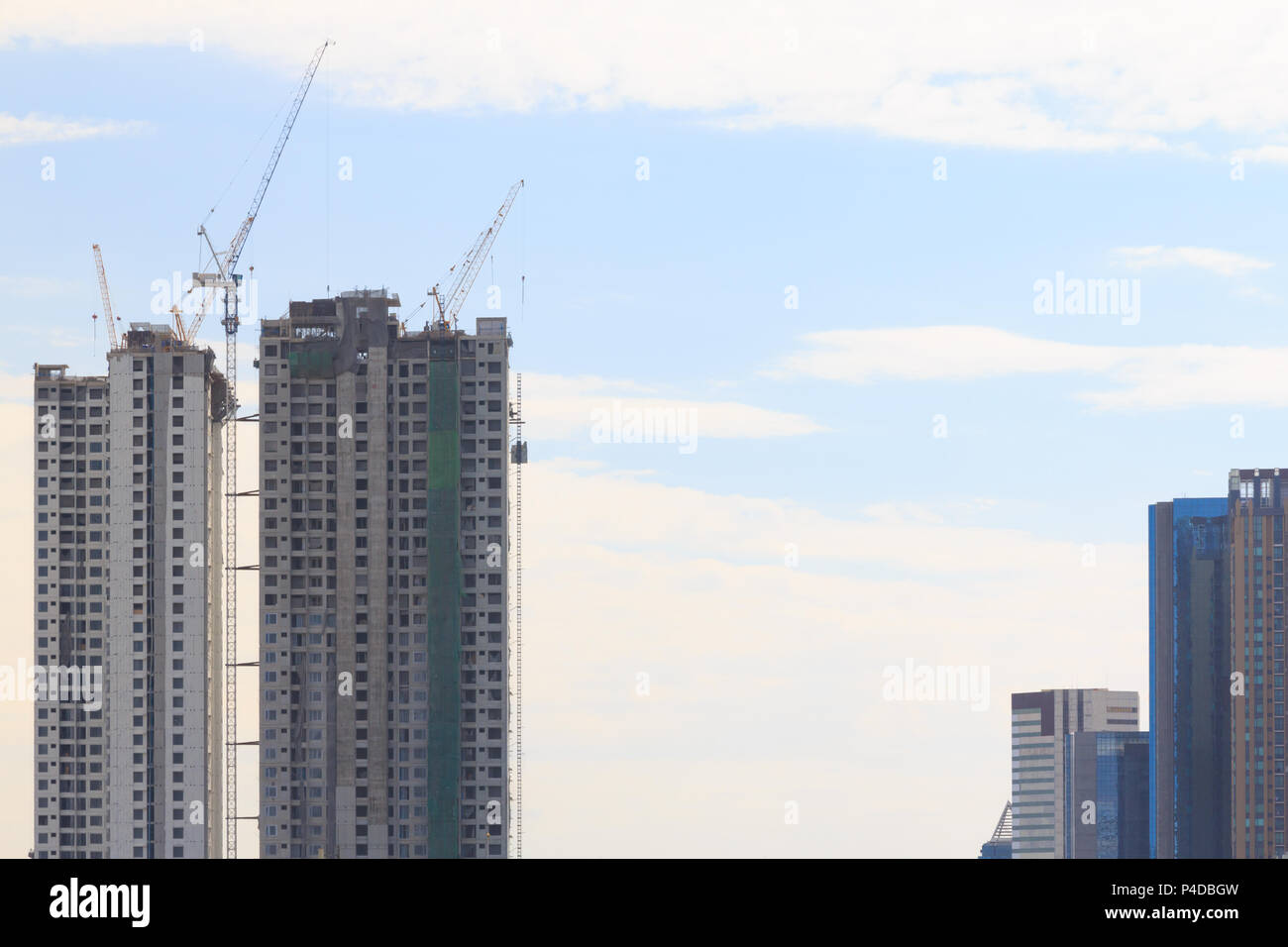 High rise buildings under construction, on blue sky background Stock ...