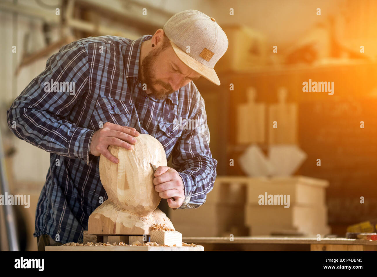 Close up of a carpenter, builder in work clothes saw to cut out ...