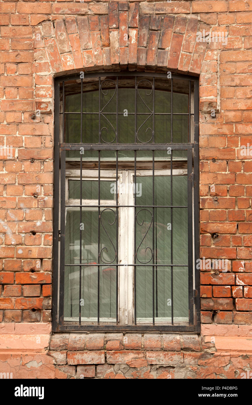 An old window with a metal grille with a metal lock. Vintage background ...