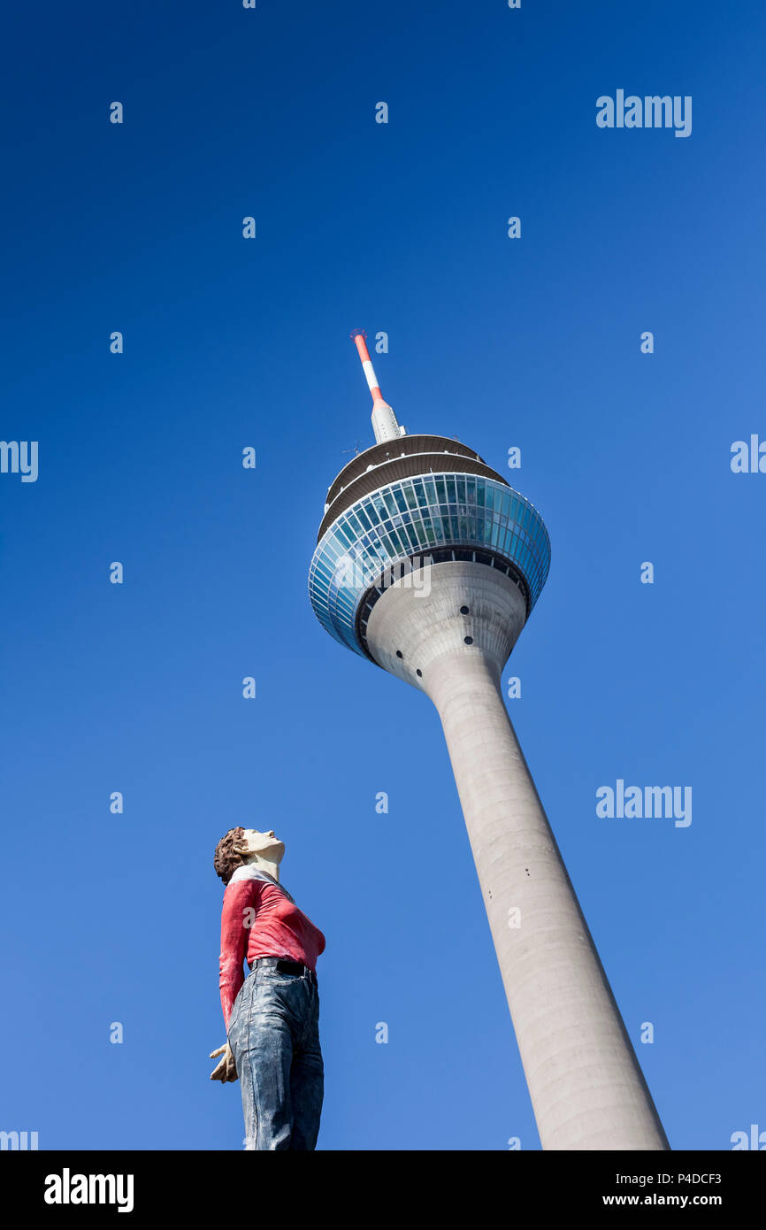 Transmission tower with womanlike statue looking up as if she is ...