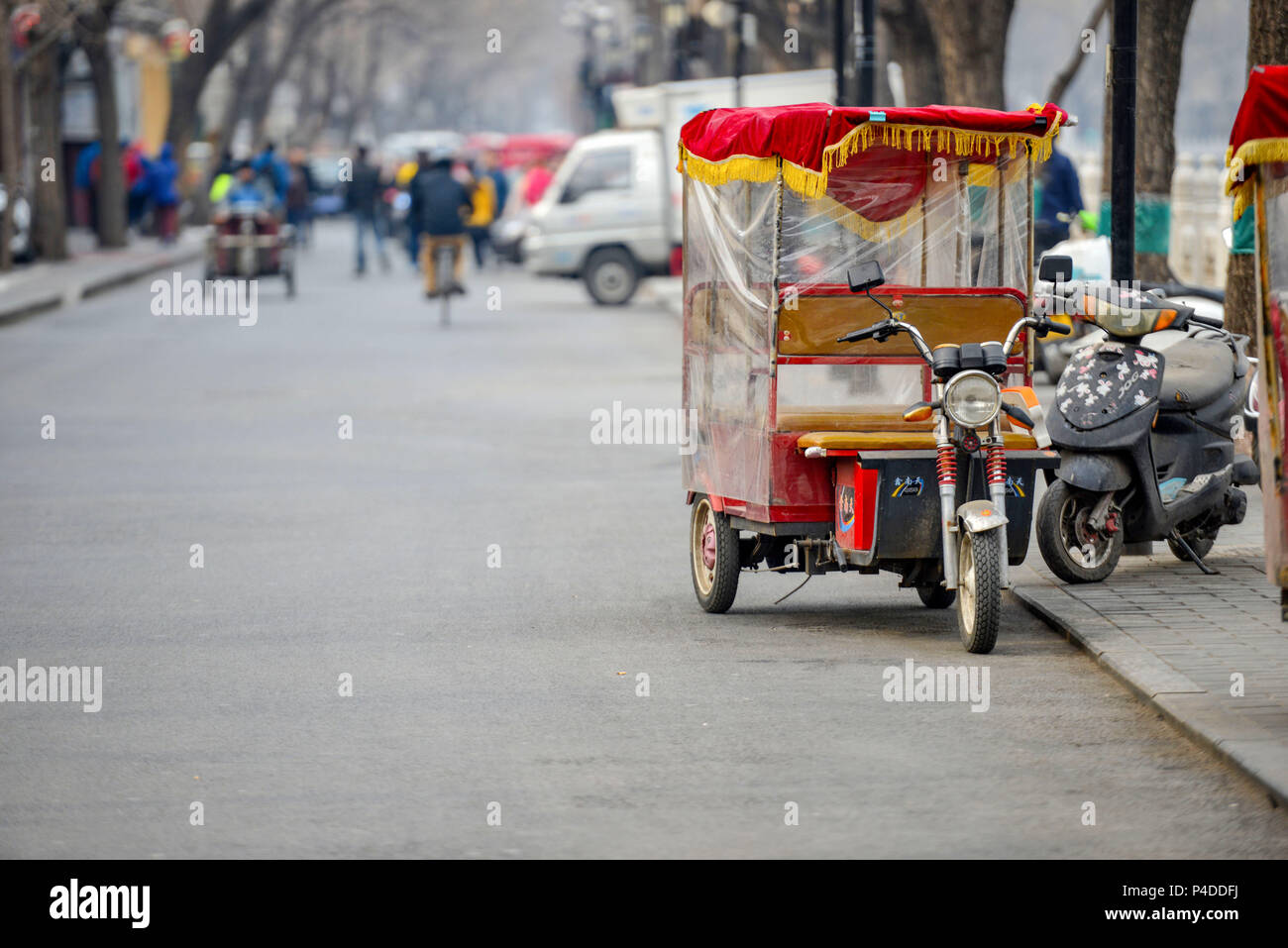 BEIJING, CHINA - MARCH 12, 2016: Tourists in a rickshaw in a hutong ...
