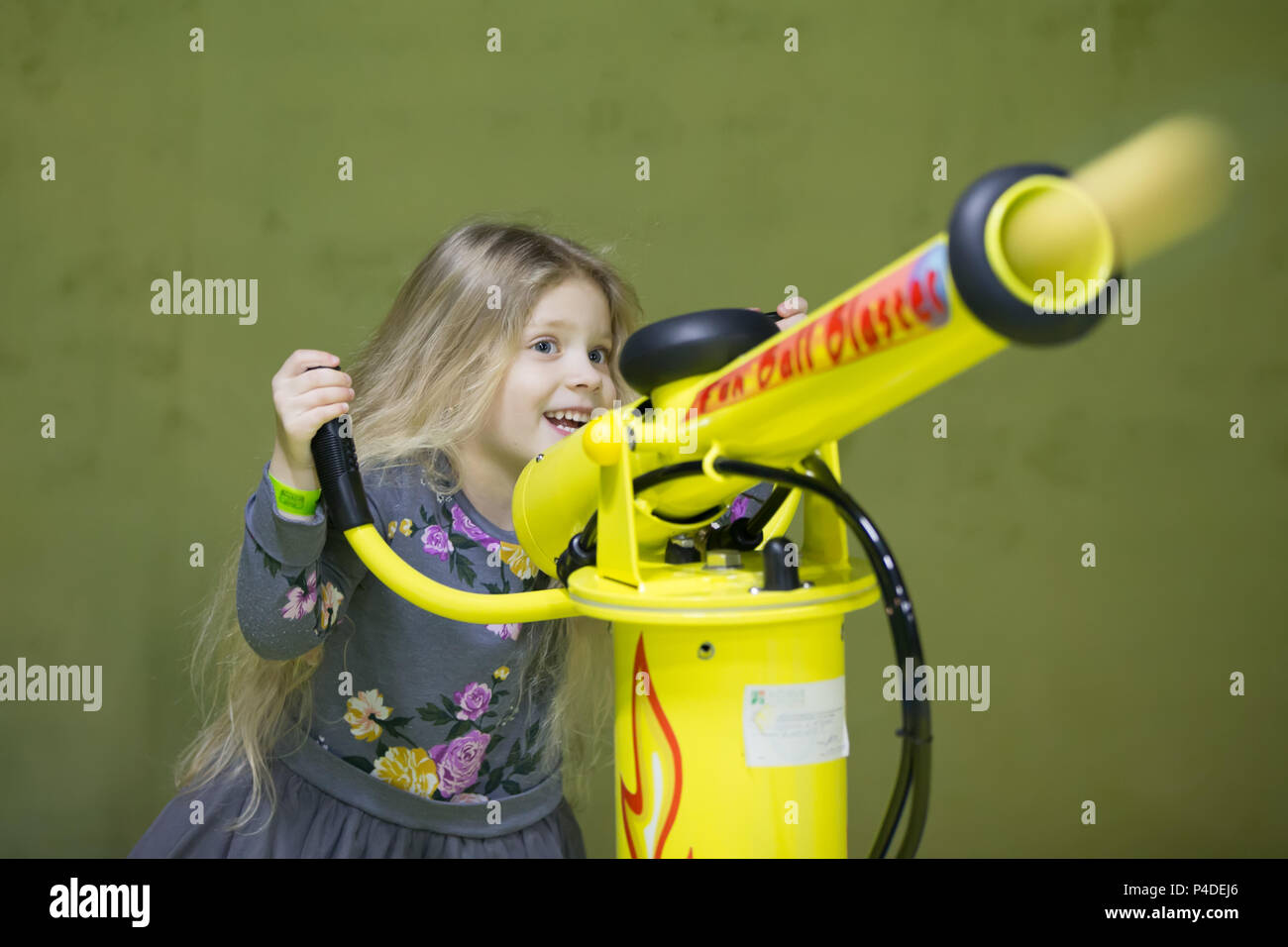 Little girl shoots with cannon balls Stock Photo - Alamy