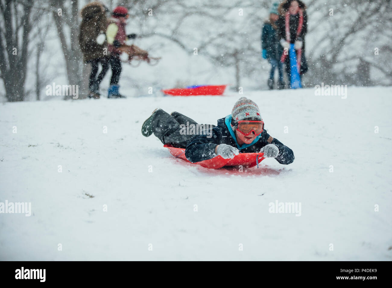 Boy sledging down hill hi-res stock photography and images - Alamy