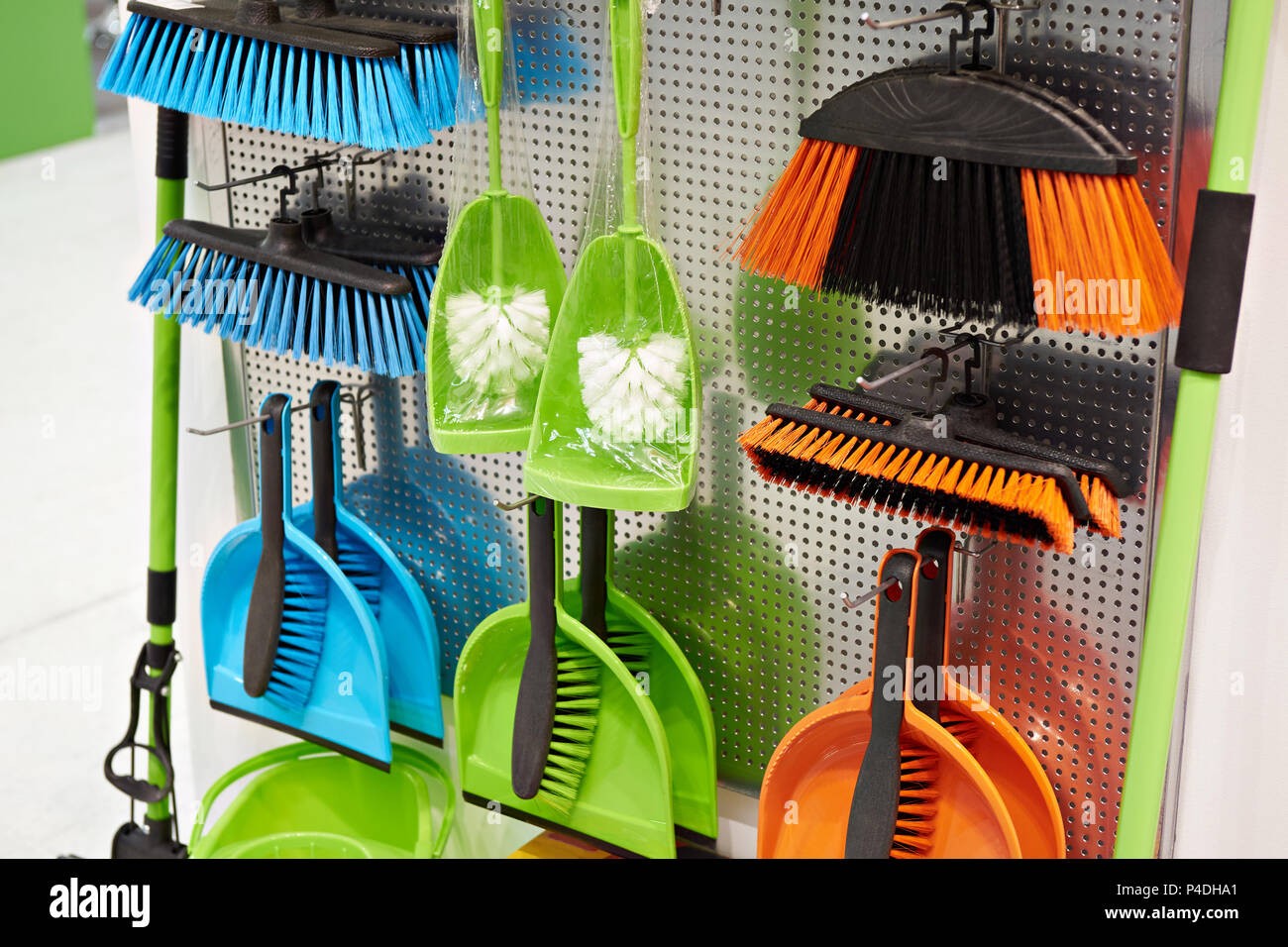 Plastic household brushes and scoops in the hardware store Stock Photo ...
