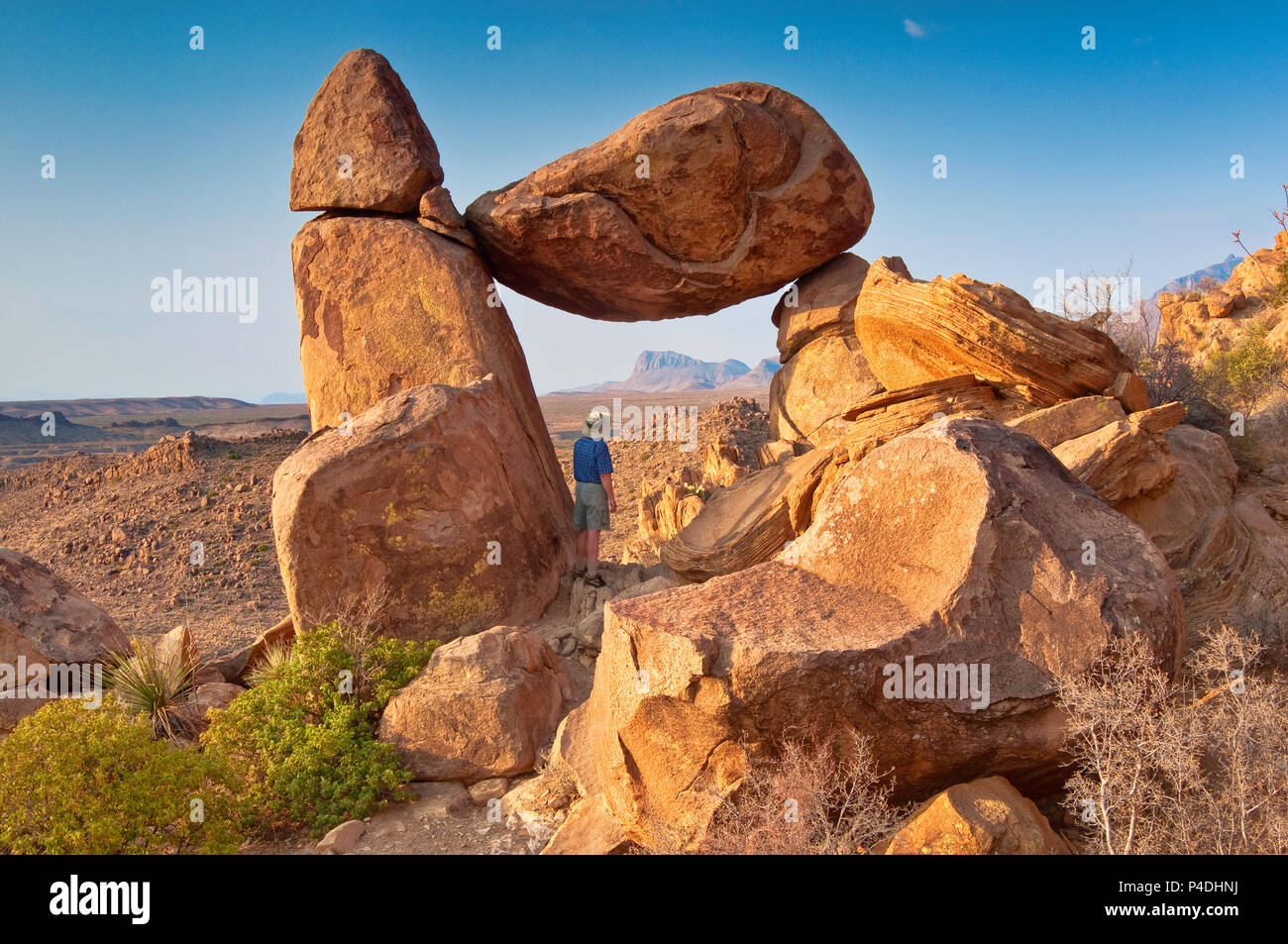 Hiker at Balanced Rock, also known as The Window, at Grapevine Hills ...