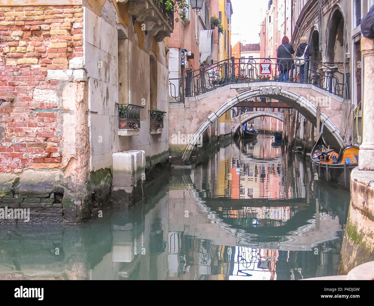 old Venice bridges reflected on narrow canals of the city through ...