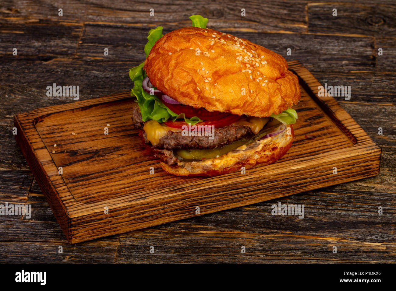 Fresh hot burger with beef, cheese and red onion Stock Photo - Alamy