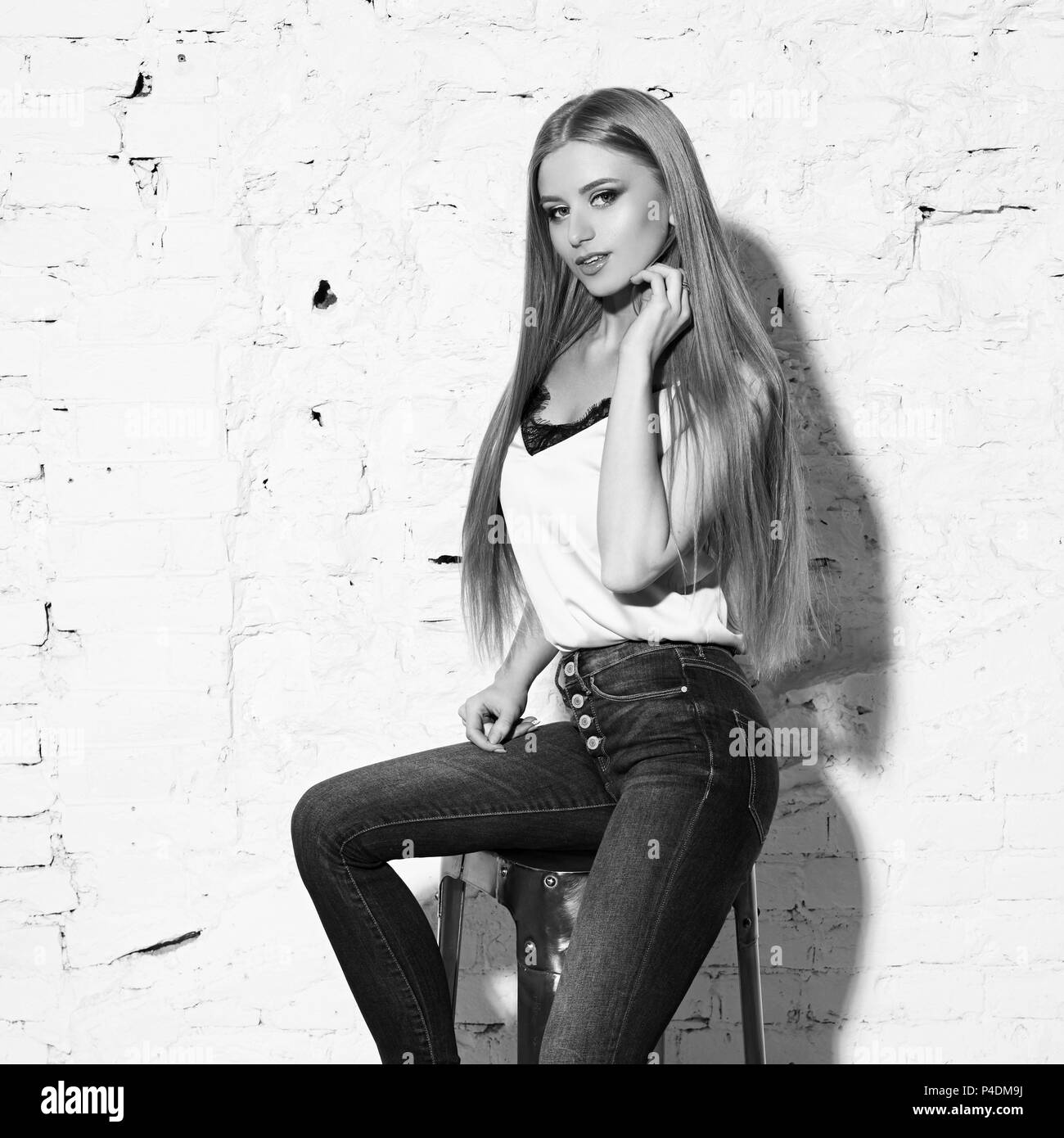 Woman crossed legs sitting fashion Black and White Stock Photos ...