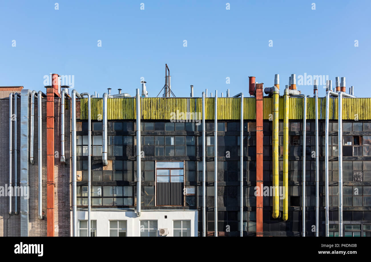 facade of the industrial building. different ventilation pipes on roof ...