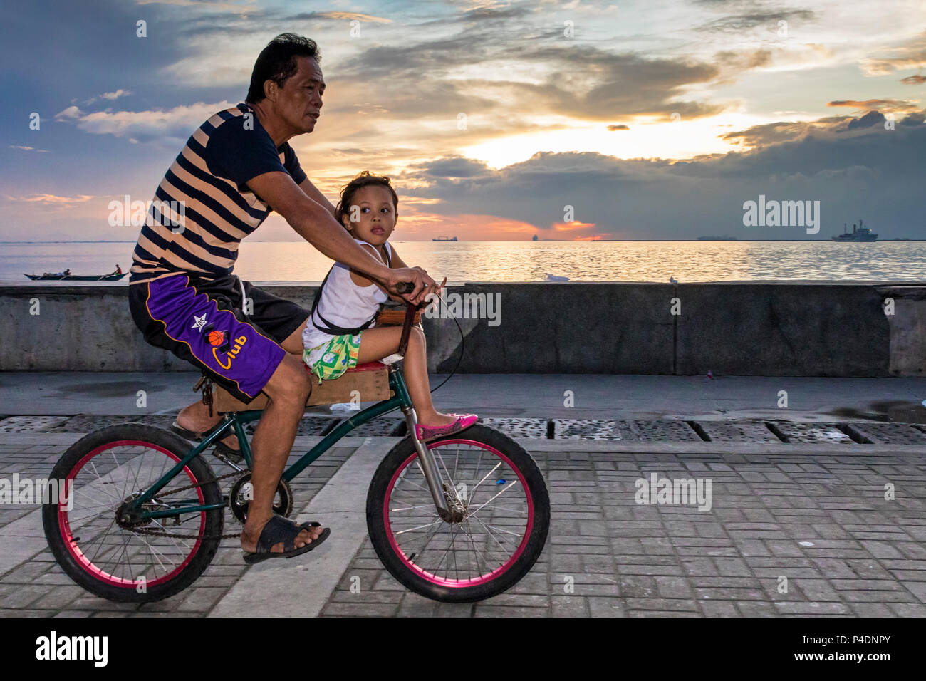 Cyclist at sunset, Manila Bay, Philippines Stock Photo - Alamy