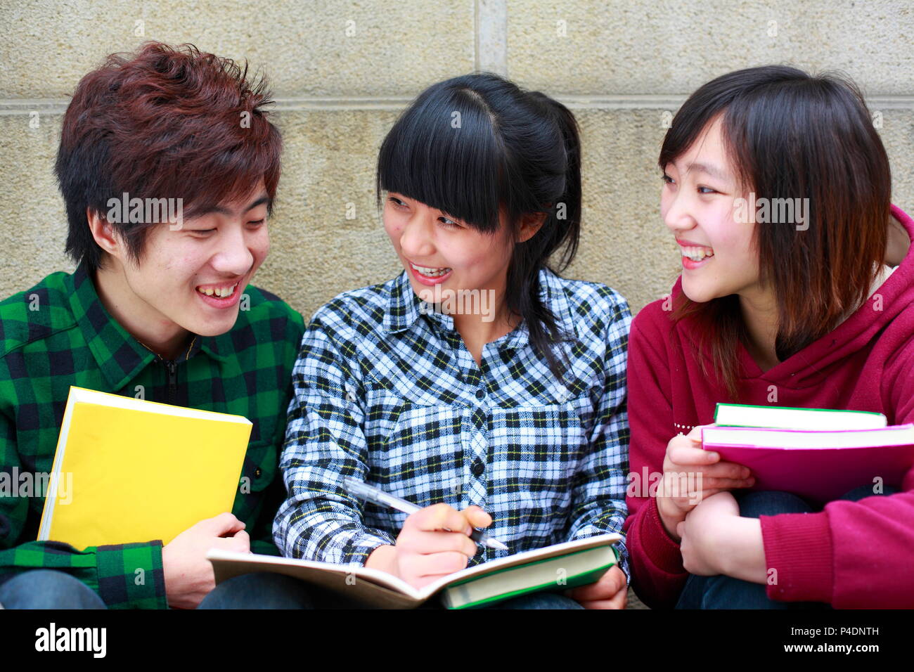 three asian college students study together in campus Stock Photo - Alamy