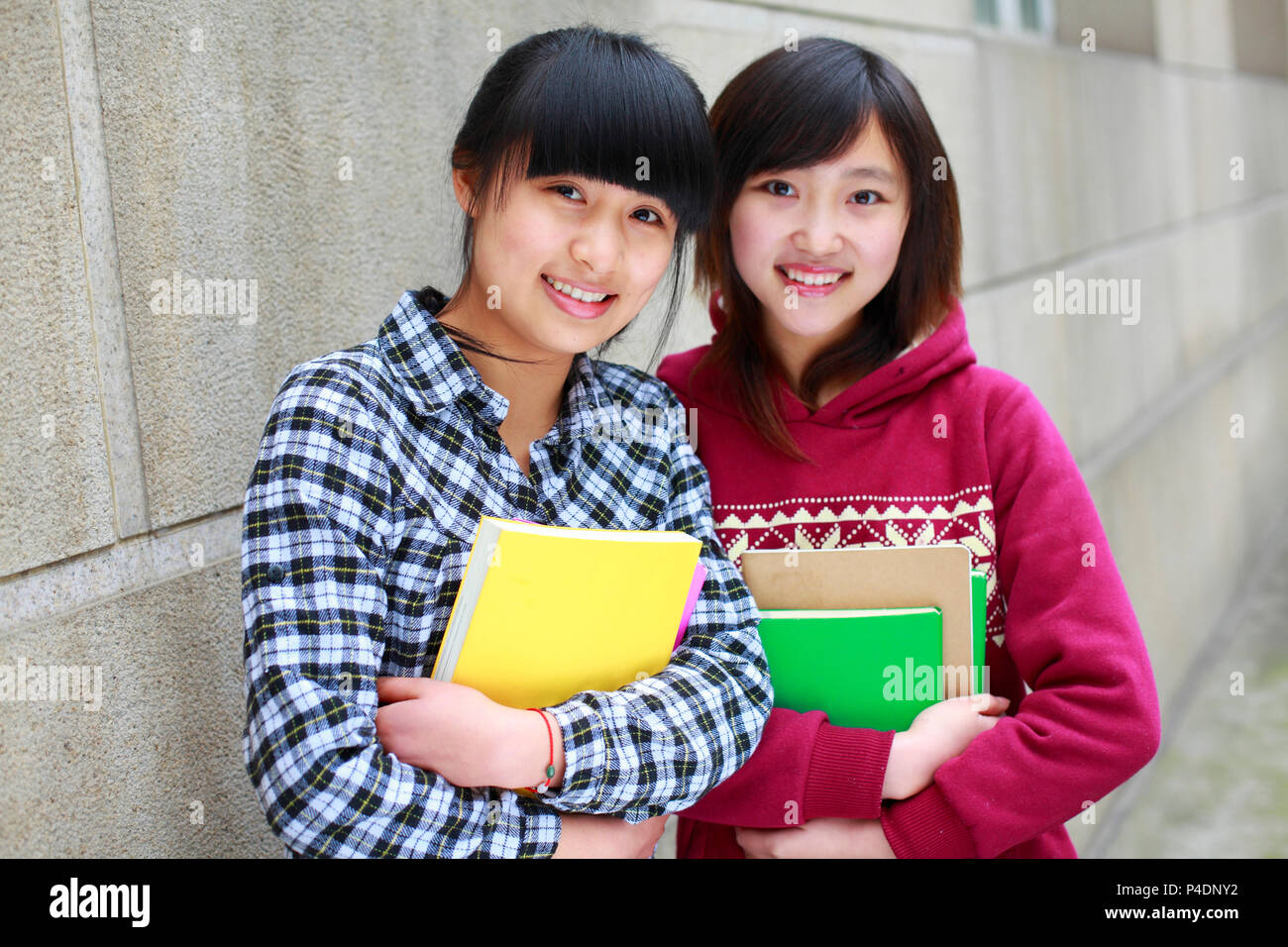 two asian college students smile at camera Stock Photo - Alamy