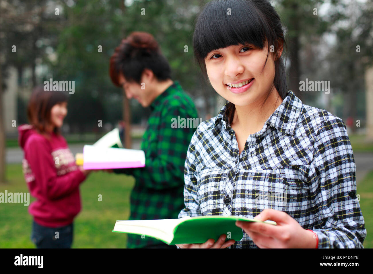 three asian college students study together in campus Stock Photo - Alamy