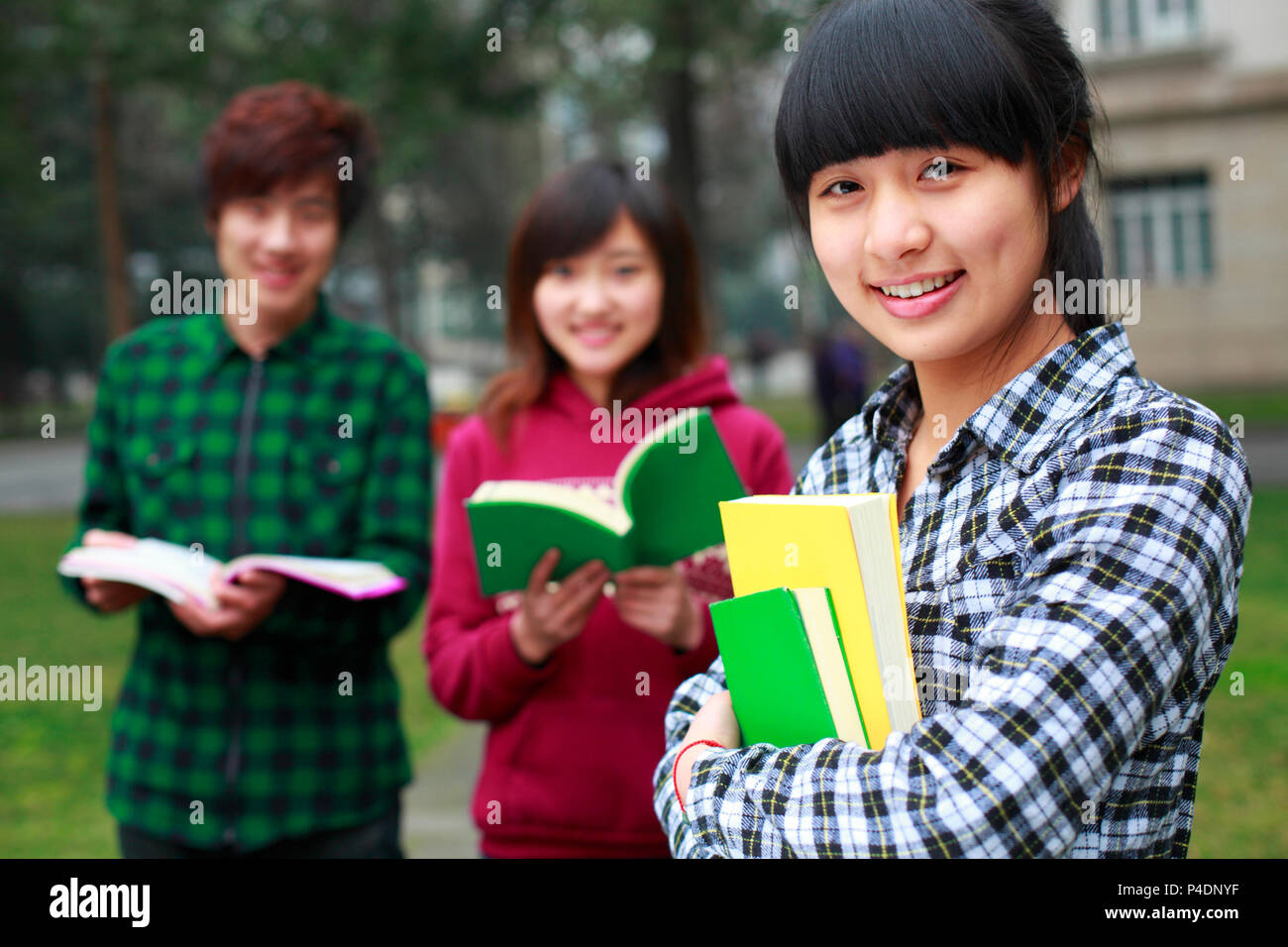 three asian college students study together in campus Stock Photo - Alamy