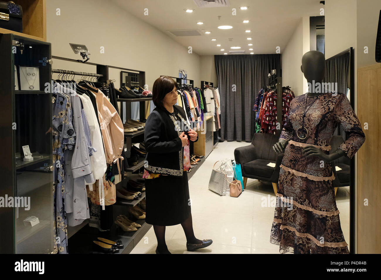 A Haredi customer trying on jacket at a fashionable clothing store in ...