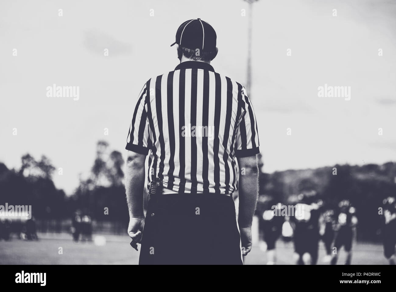 American Football line empire, referee supervise a match. Toned image ...
