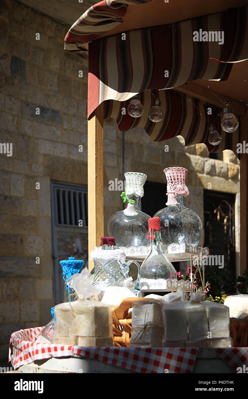 A cart with traditional glass water pitchers covered with crochet lids ...