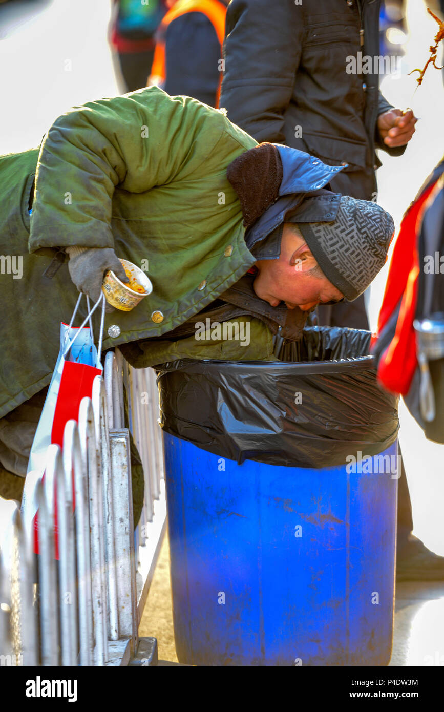 Homeless man searching rubbish bin hi-res stock photography and images ...