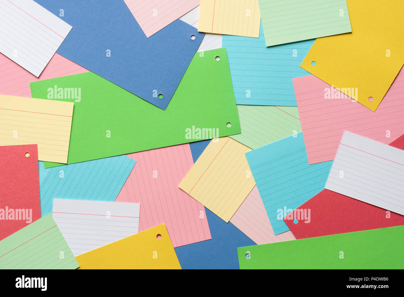Vibrant background with a multitude of paper notes spread on an office ...