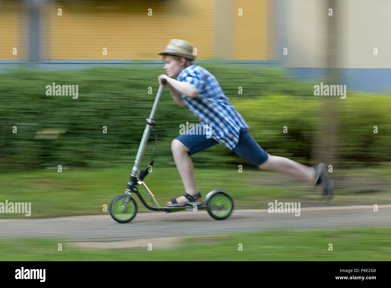 young boy riding his scooter Stock Photo - Alamy