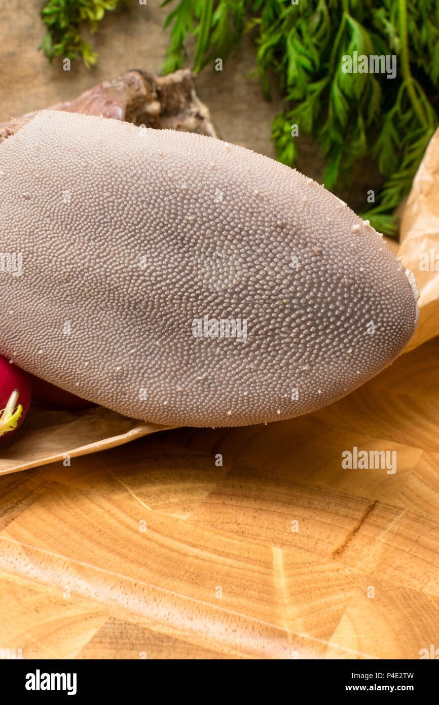 boiled tongue with carrot on rustic background. Raw, beef or pork ...