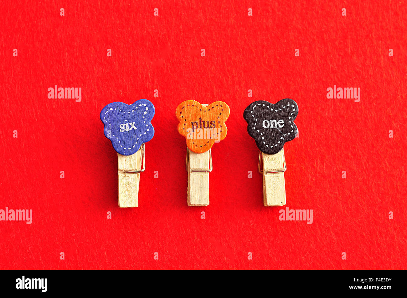 Six plus one on a red background Stock Photo - Alamy